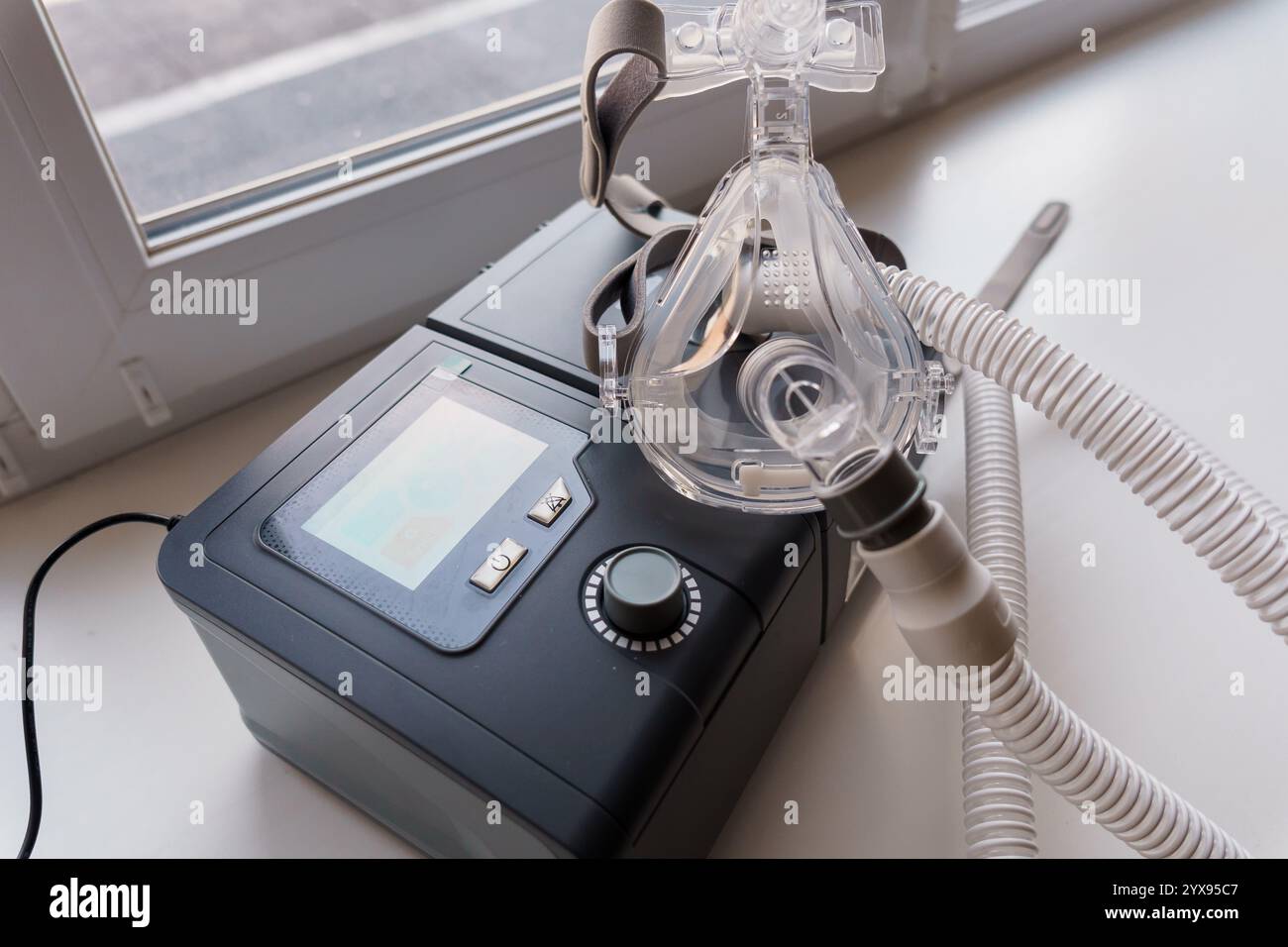Medical CPAP Machine with Breathing Mask Set Against a Window Stock ...