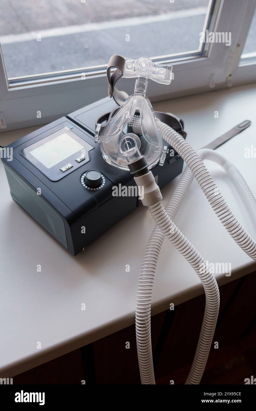 Medical CPAP Machine with Mask and Tubing on Windowsill Stock Photo - Alamy