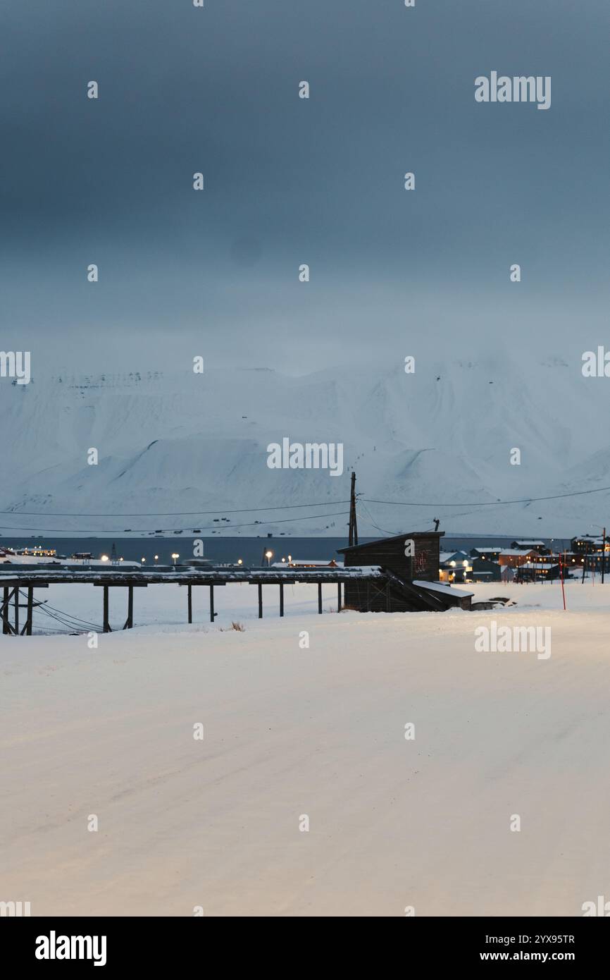 Pipes above the ground in front of fjord in Longyearbyen, Svalbard ...