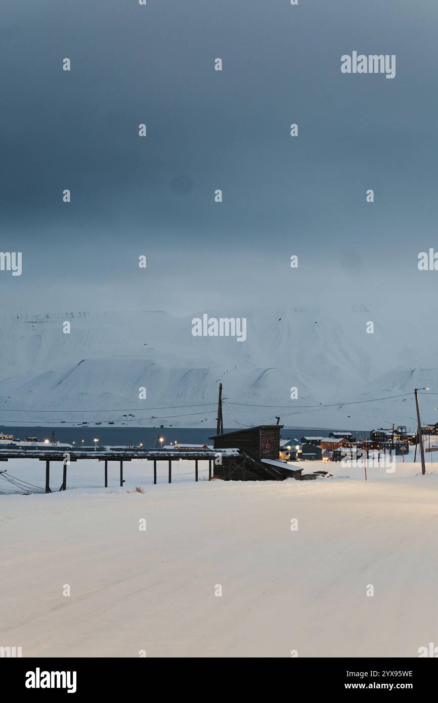 Pipelines in front of snowy fjord in Longyearbyen, Svalbard in the ...