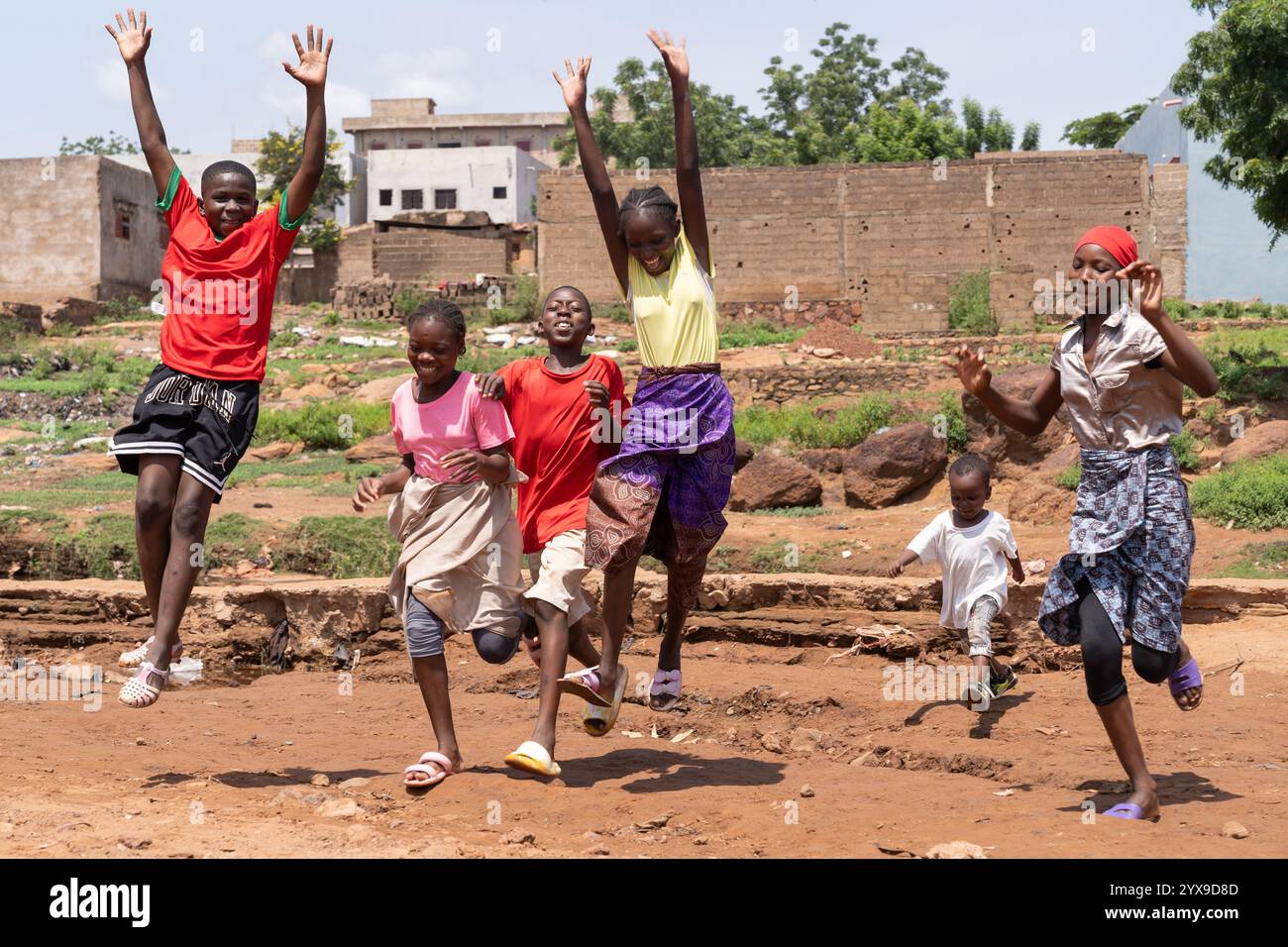 Group of West African children happily competing with each other in the ...