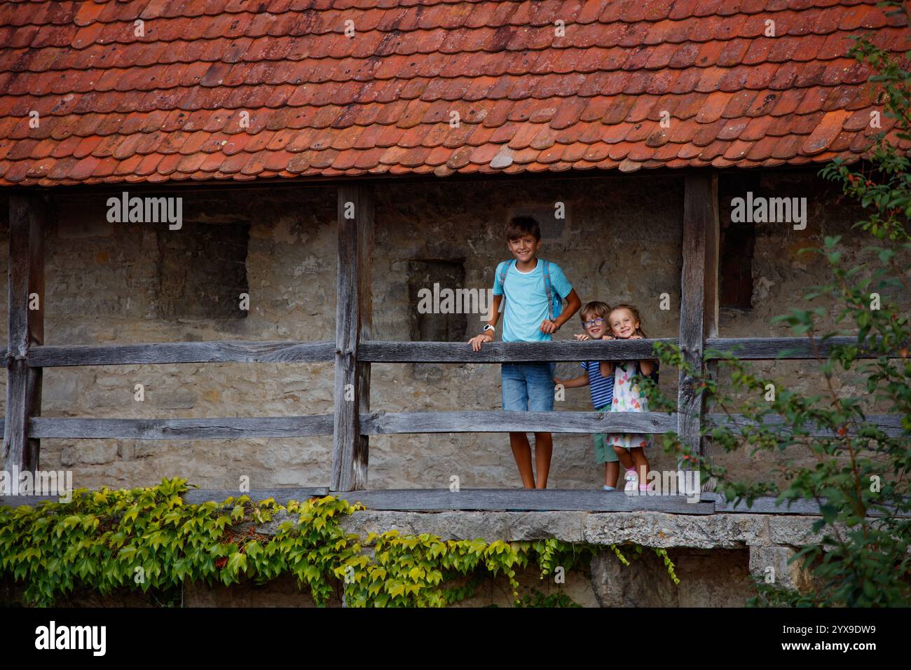 Children enjoy the view from an old stone building's balcony Stock ...
