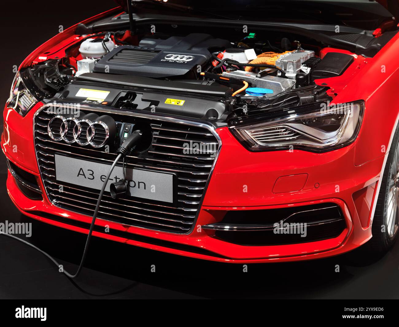 Closeup of Audi A3 e-tron electric car with a power plug being charged ...