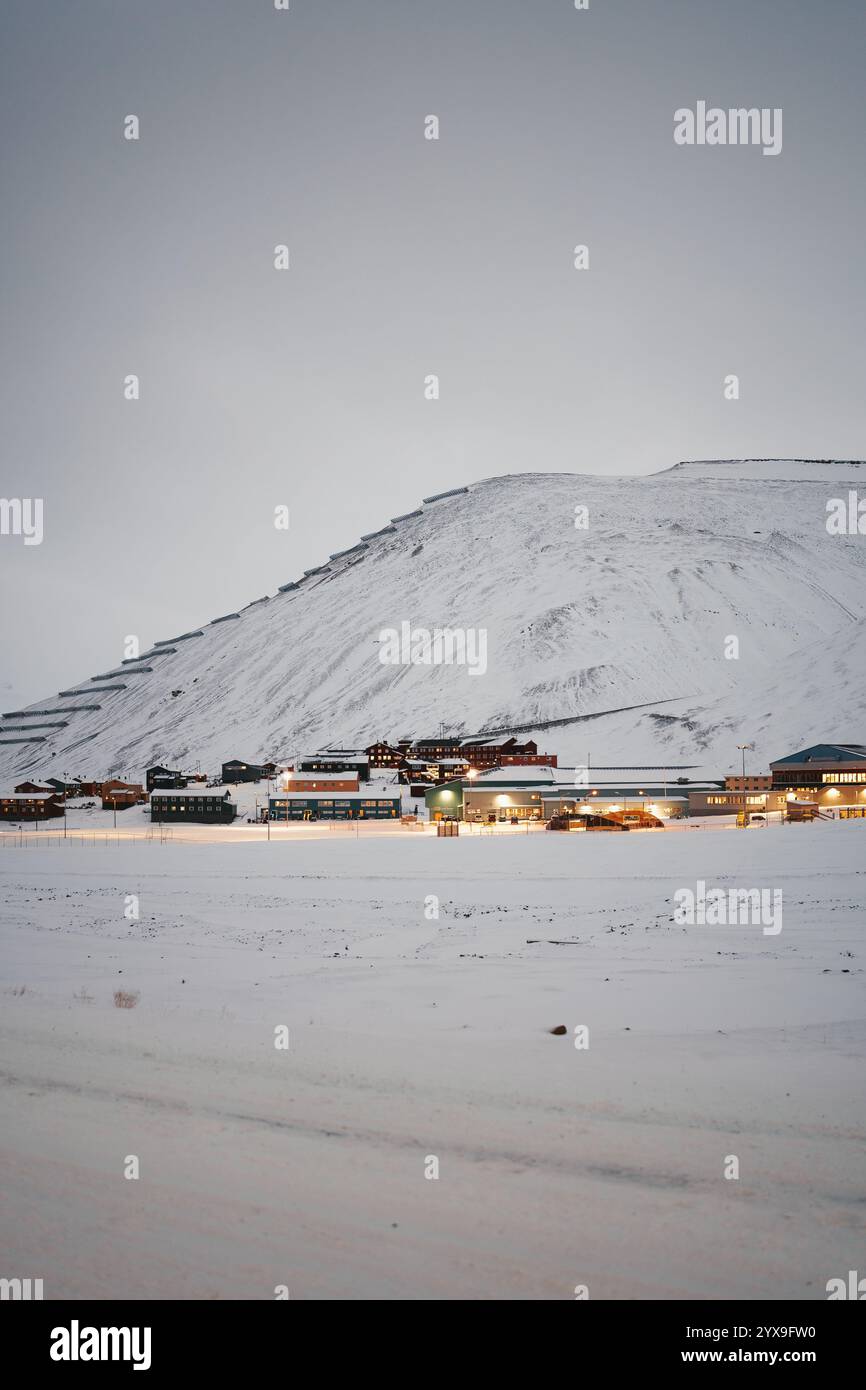 Snowy arctic mountain with avalanche barriers behind Longyearbyen ...