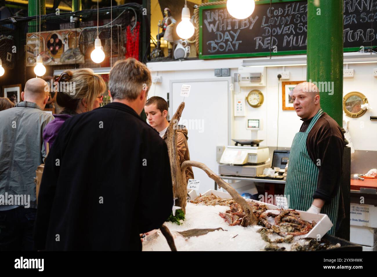Shoppers at a fishmongers at Borough Market in London, United Kingdom ...
