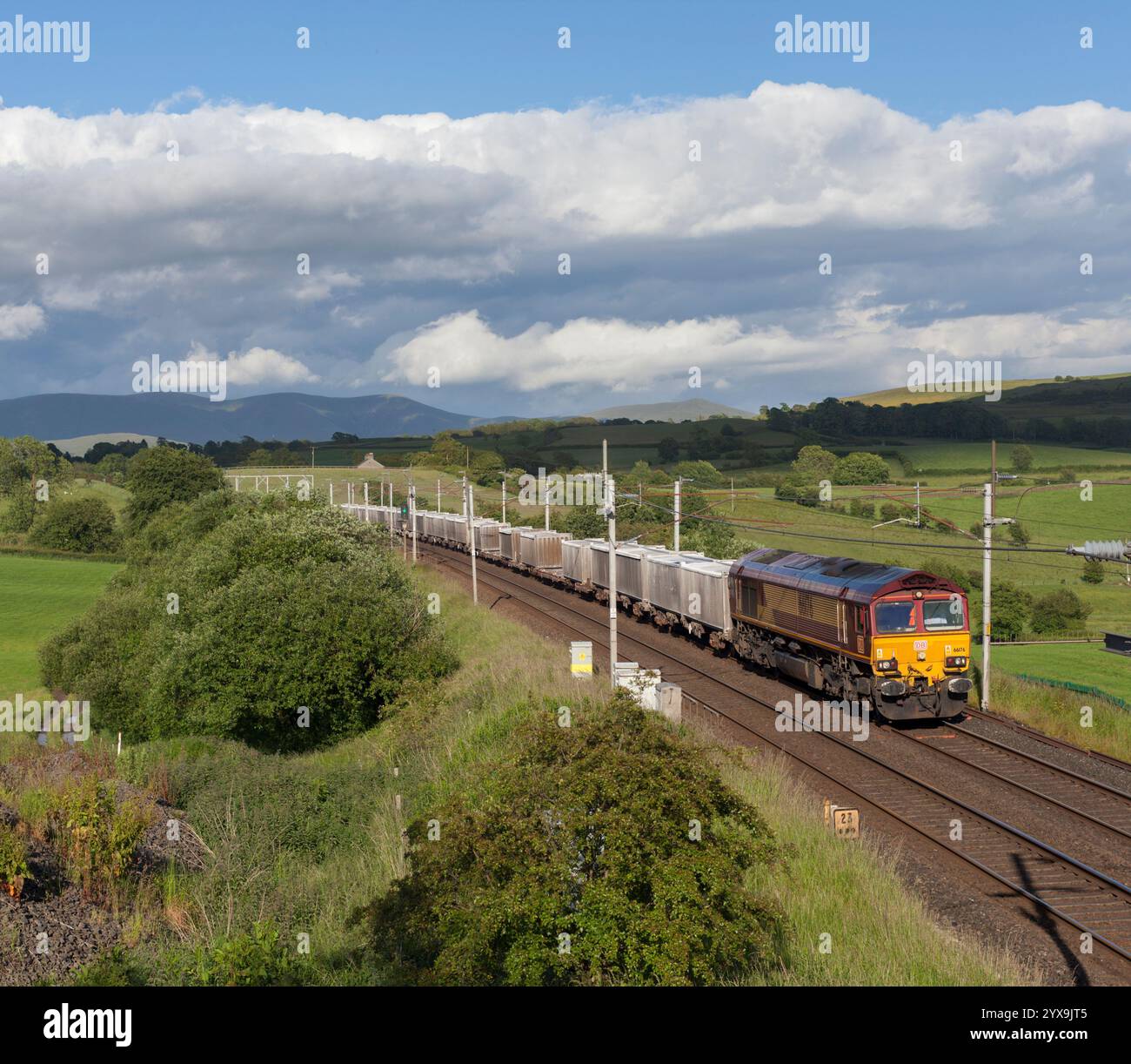DB Cargo class 66 locomotive in EWS livery passing Docker (north of ...