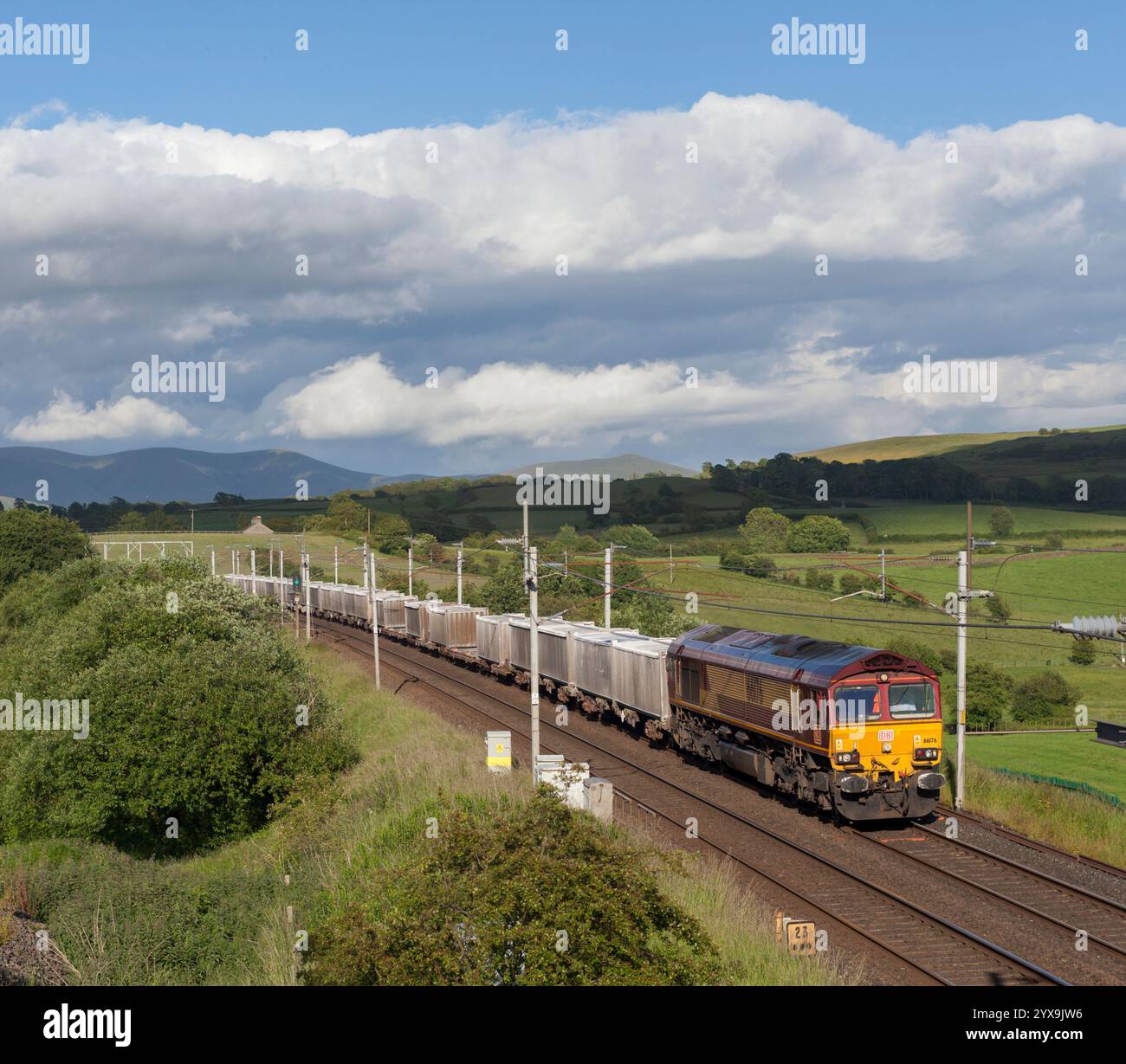 DB Cargo class 66 locomotive in EWS livery passing Docker (north of ...