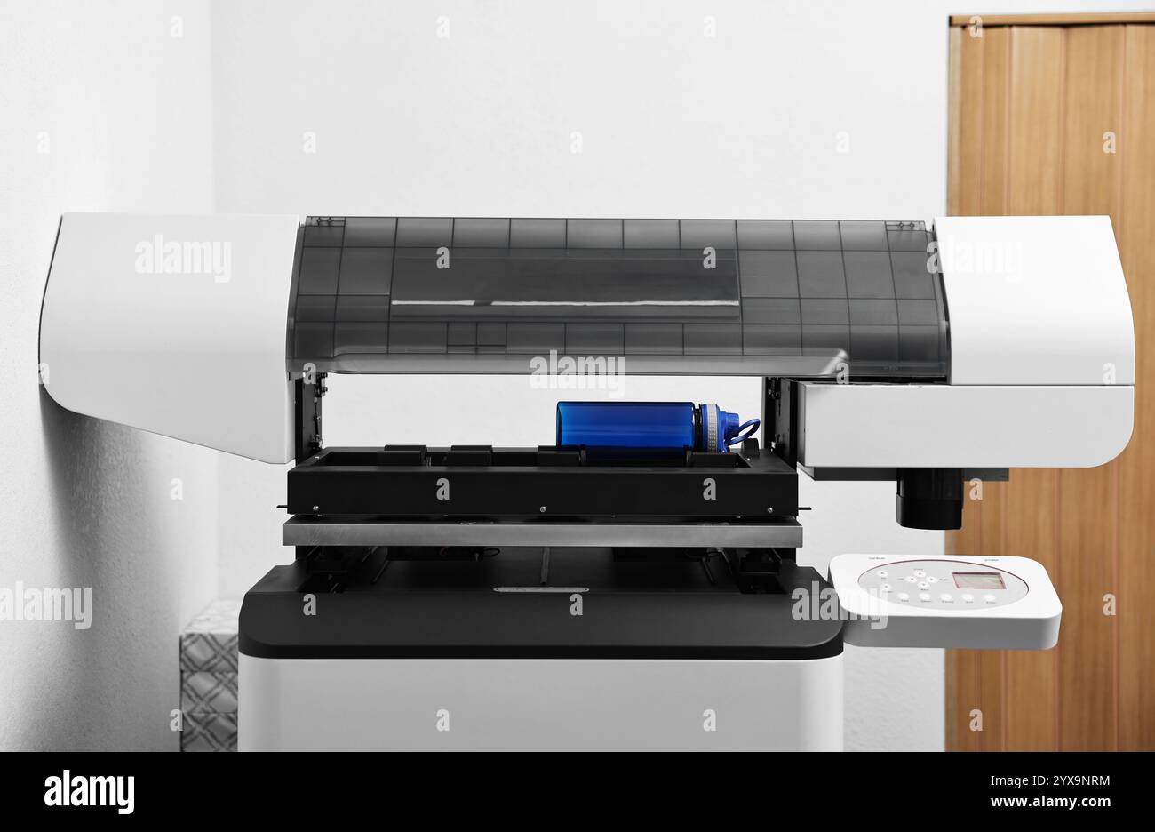 Modern printer and empty bottle in room Stock Photo - Alamy