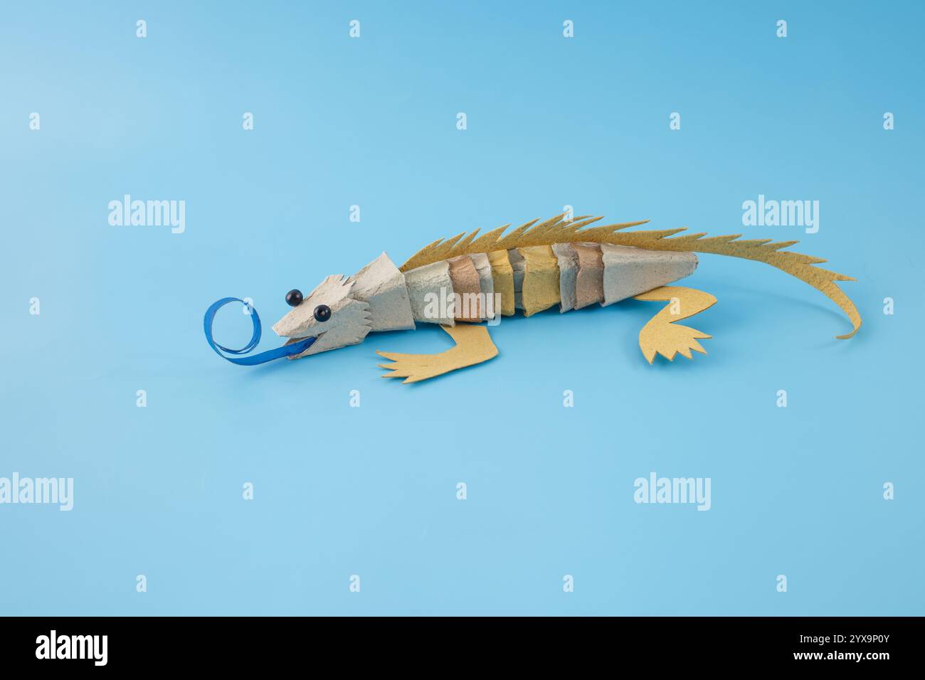 carton egg box lizard has a segmented body with different shades of ...