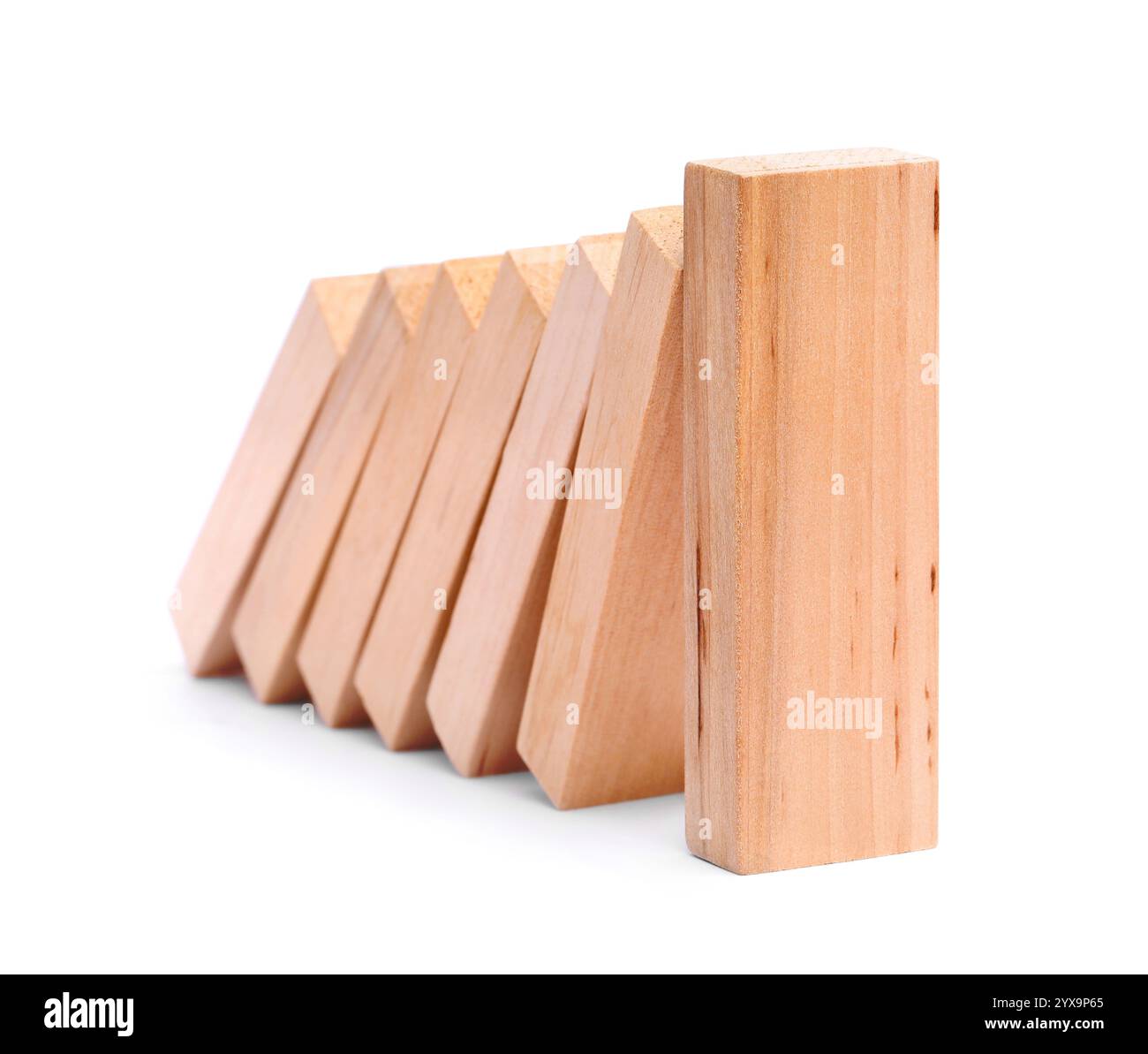 Domino effect. Wooden blocks falling on white background Stock Photo ...