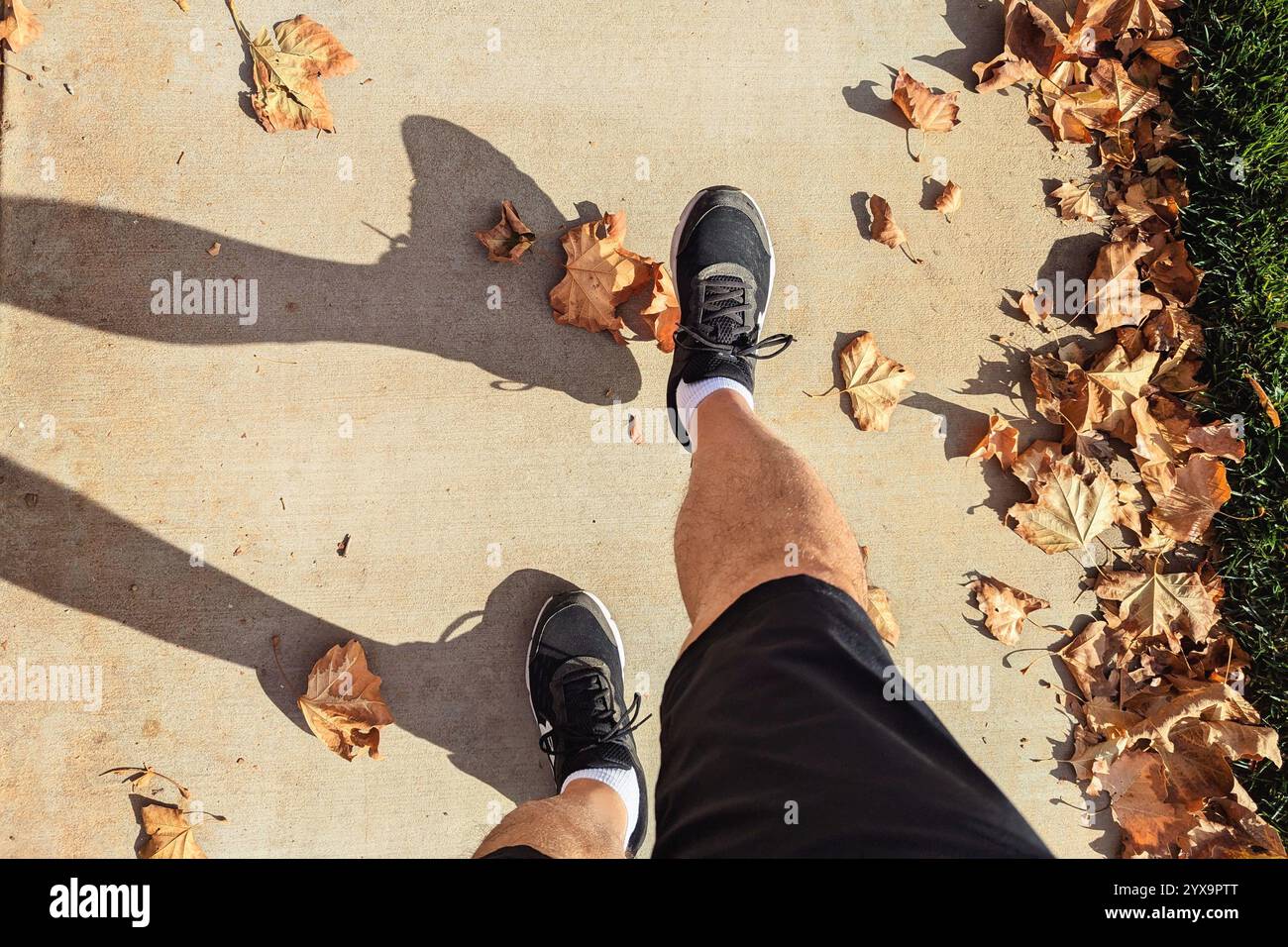 Looking down at feet while walking for exercise Stock Photo - Alamy