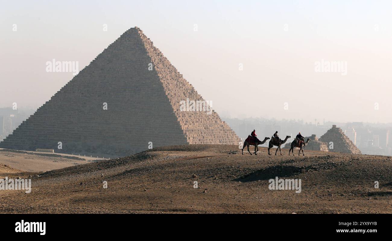 Tourism in Egypt Tourists ride on camels as they visit the Giza Plateau ...