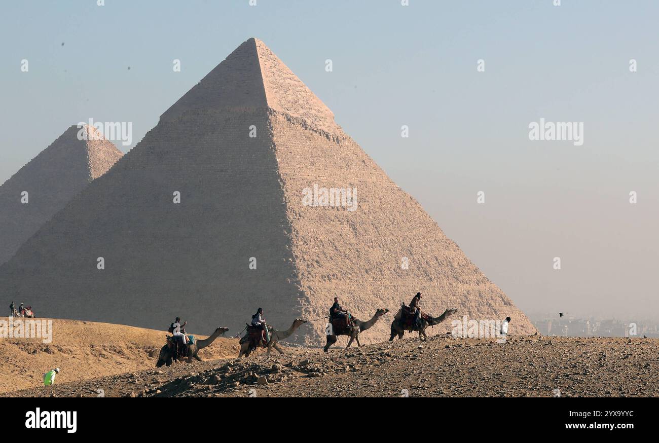 Tourism in Egypt Tourists ride on camels as they visit the Giza Plateau ...