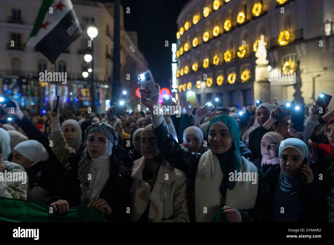 Protesters turn on their mobile phones during a rally. Syrian residents ...