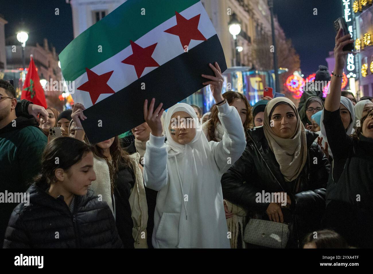 A female protester raises the Syrian flag during a rally. Syrian ...