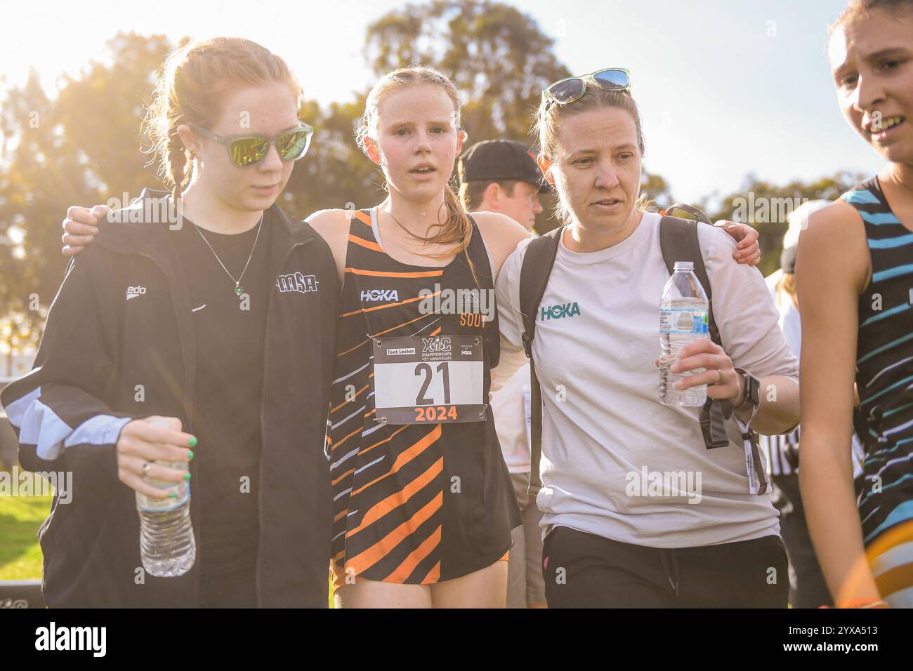 Elizabeth Leachman is helped over to the podium after the Foot Locker ...
