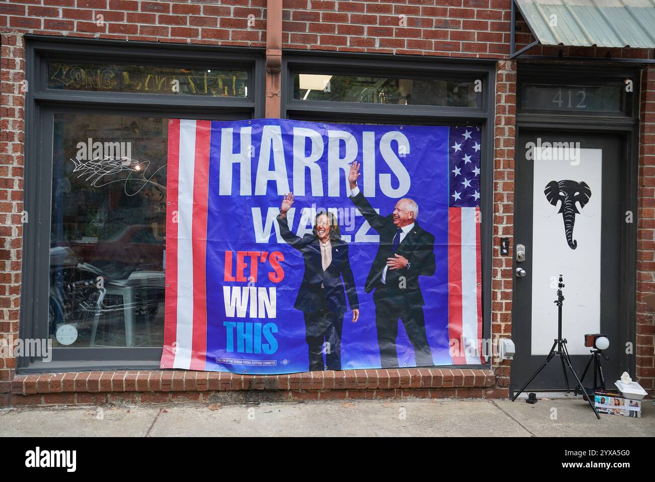 A promotional banner for Kamala Harris and Tim Walz is seen at the ...