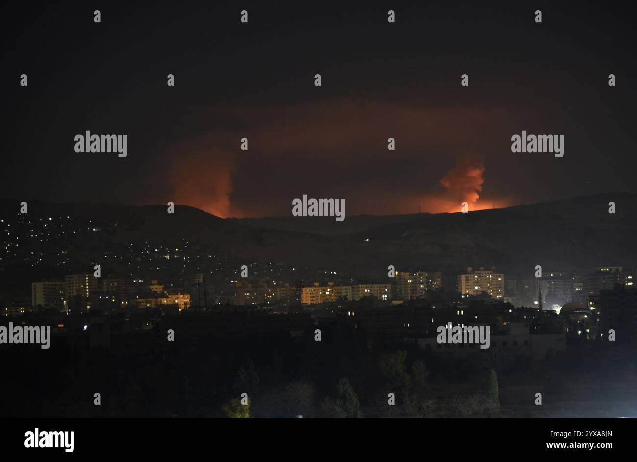 Damascus, Syria. 14th Dec, 2024. Smoke rises as a result of a series of ...