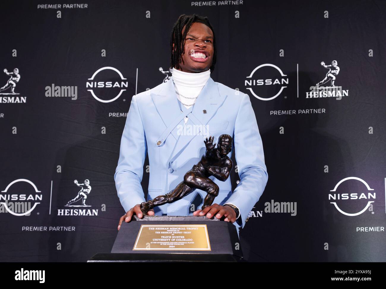 Colorado CB/WR Travis Hunter puts his hands on the Heisman Trophy at a ...
