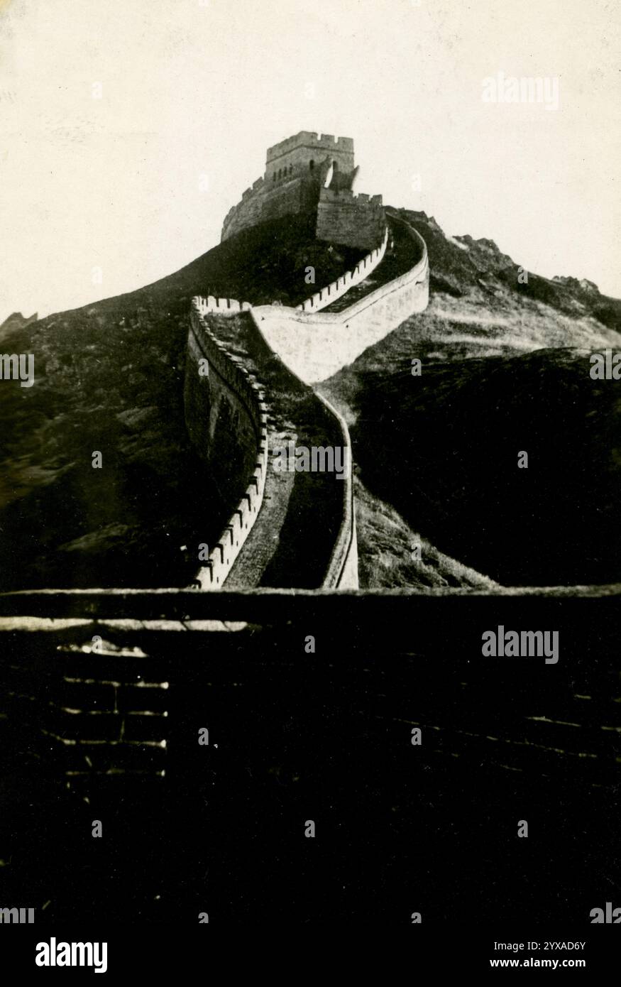 Ancient stone structure winding along a hillside under a clear sky in a ...