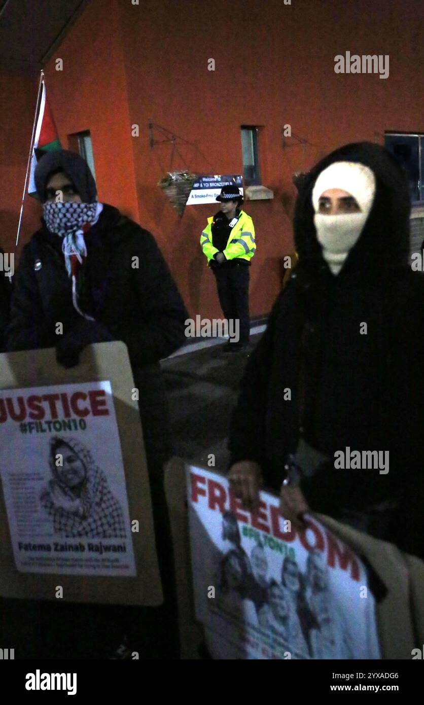 Reigate, England, UK. 14th Dec, 2024. Supporters in fading light hold ...