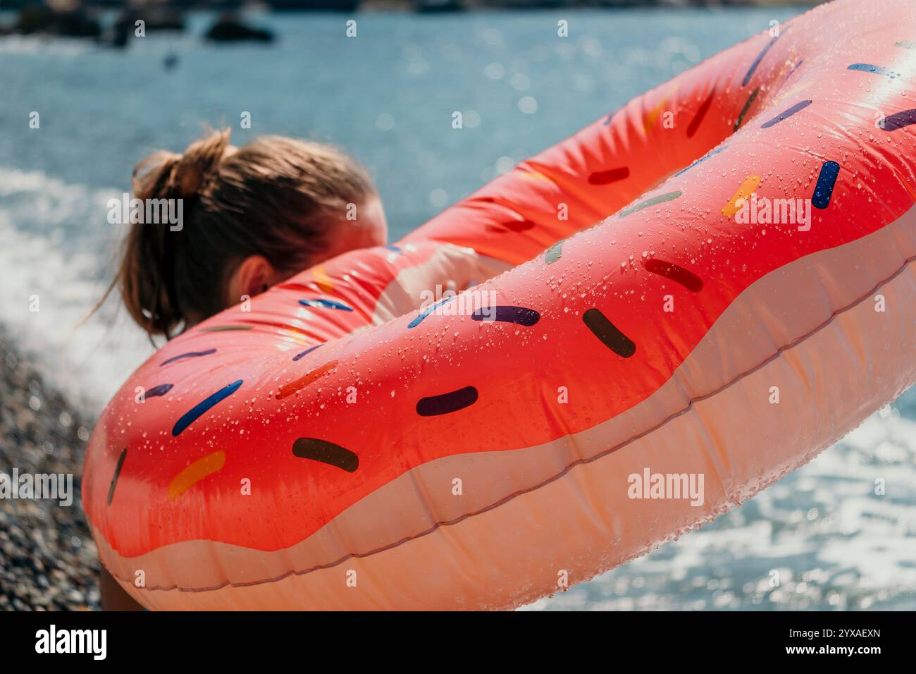 Donut Pool Float in a Sea of Blue Stock Photo - Alamy