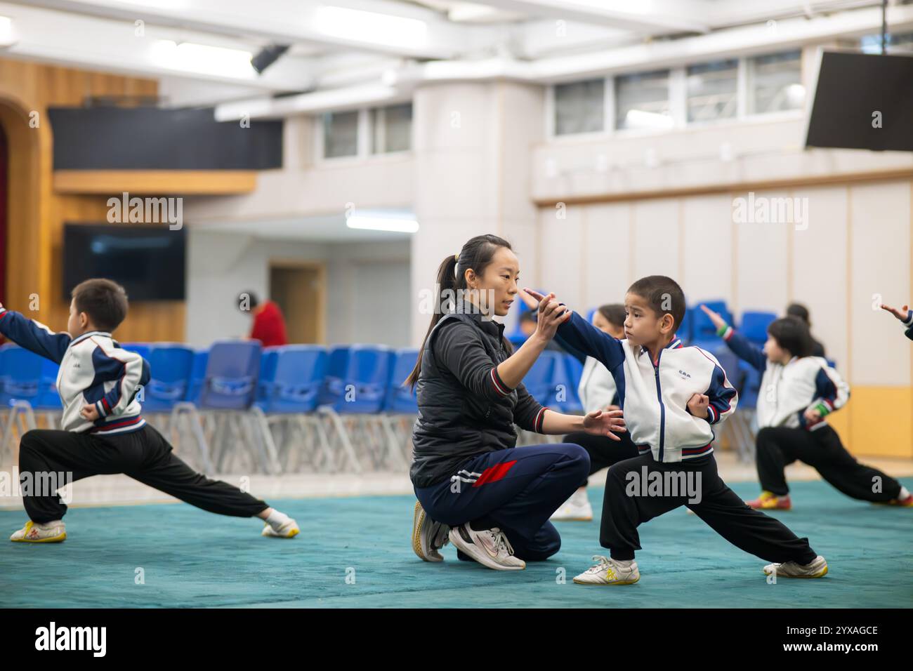 Beijing, China. 13th Dec, 2024. Li Yi corrects a motion for a student during an after-school ...