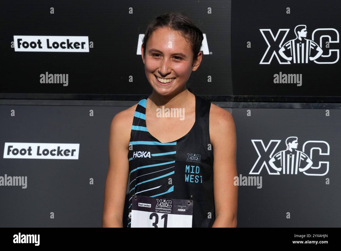 Victoria Garces poses after placing second in the girls race in 17:39.9 ...