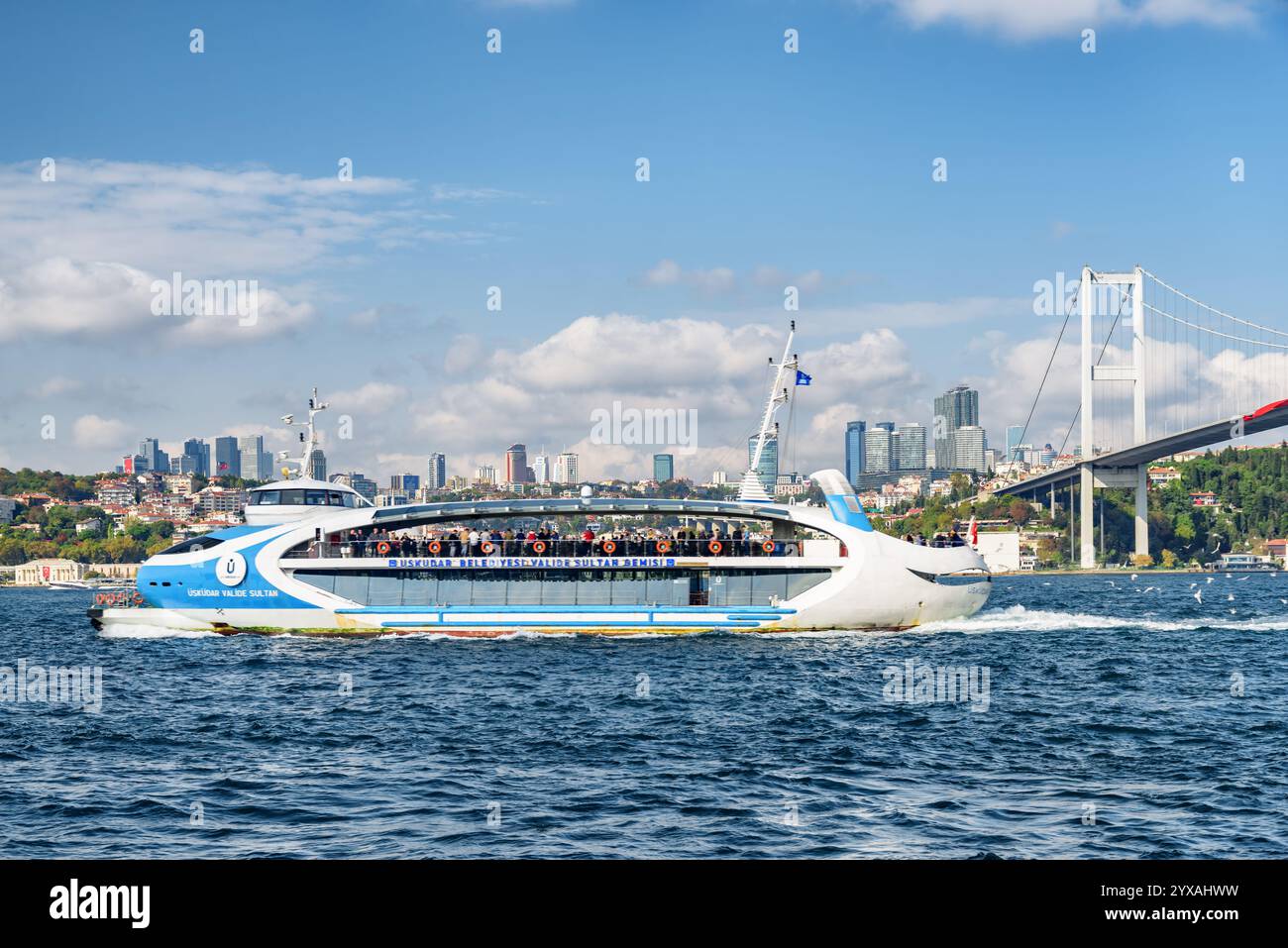 Tourist boat crossing the Bosporus. View of the Bosphorus Bridge Stock ...