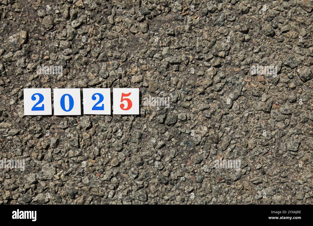 Numbers of 2025 year. Paper square numbers on the stone road background ...