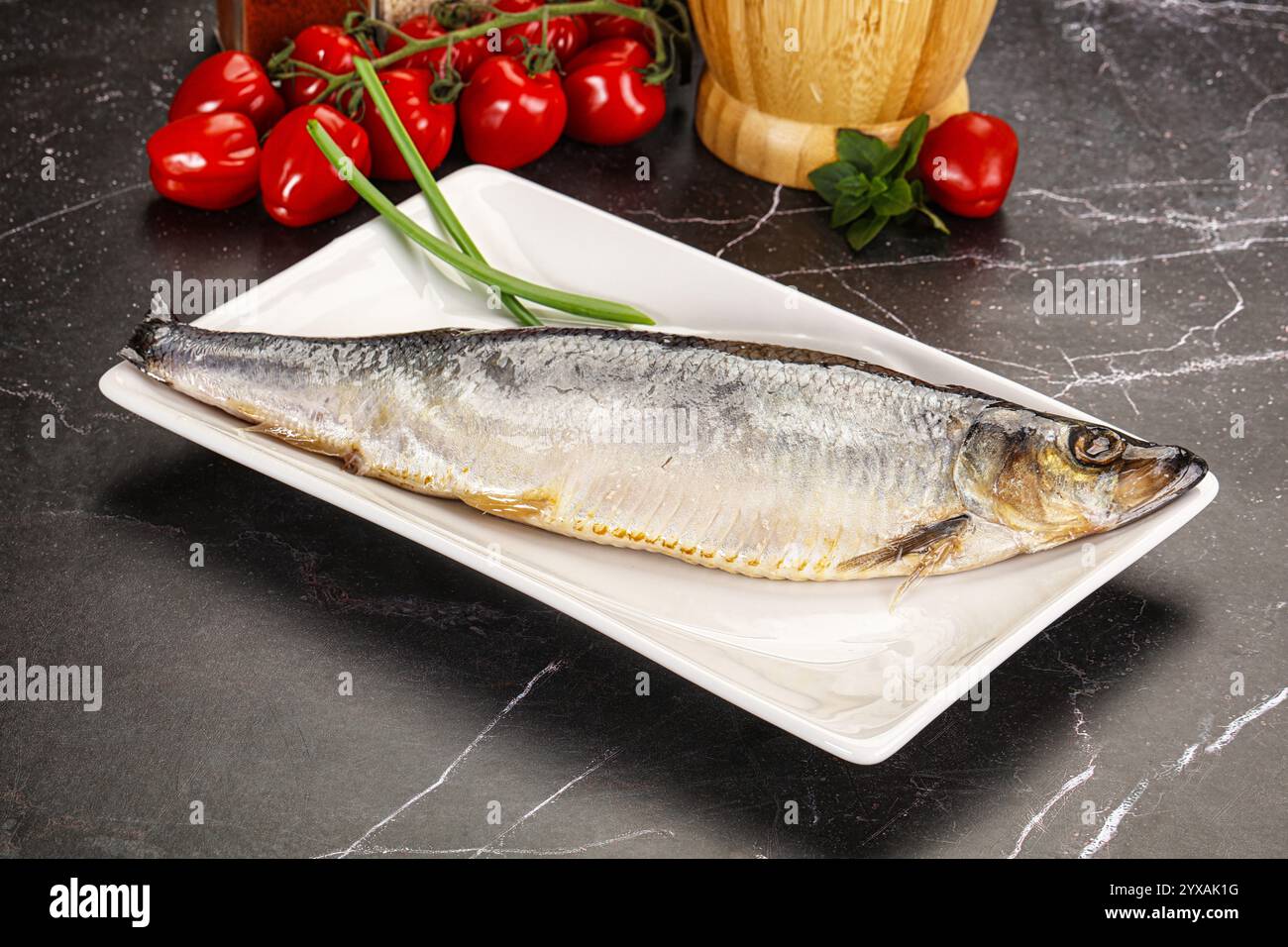 Whole raw salted herring fish in the plate Stock Photo - Alamy