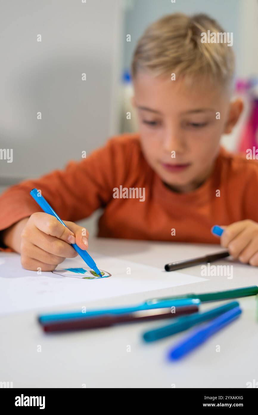 Child using colorful markers to draw, developing creativity and fine ...
