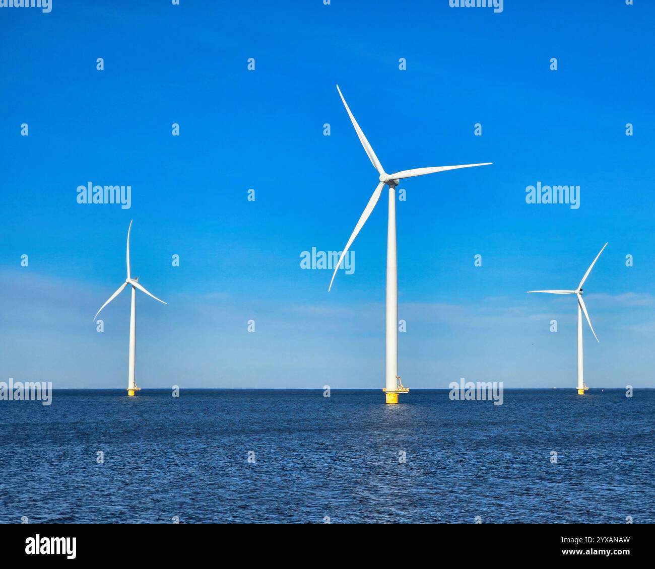Windmill park in the ocean, view of windmill turbines generating green ...