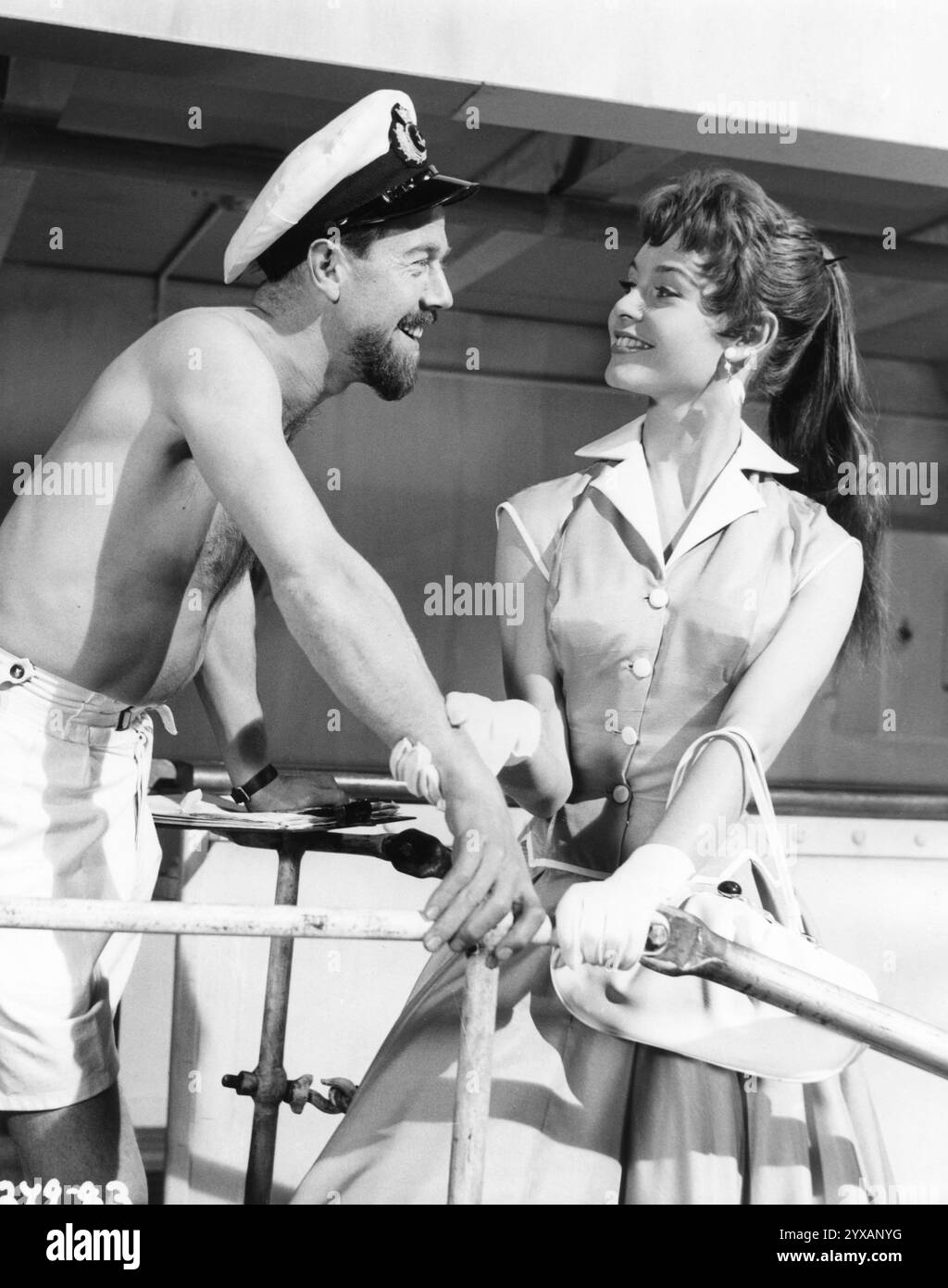MICHAEL MEDWIN and French actress BRIGITTE BARDOT in a scene from DOCTOR AT SEA 1955 Director ...