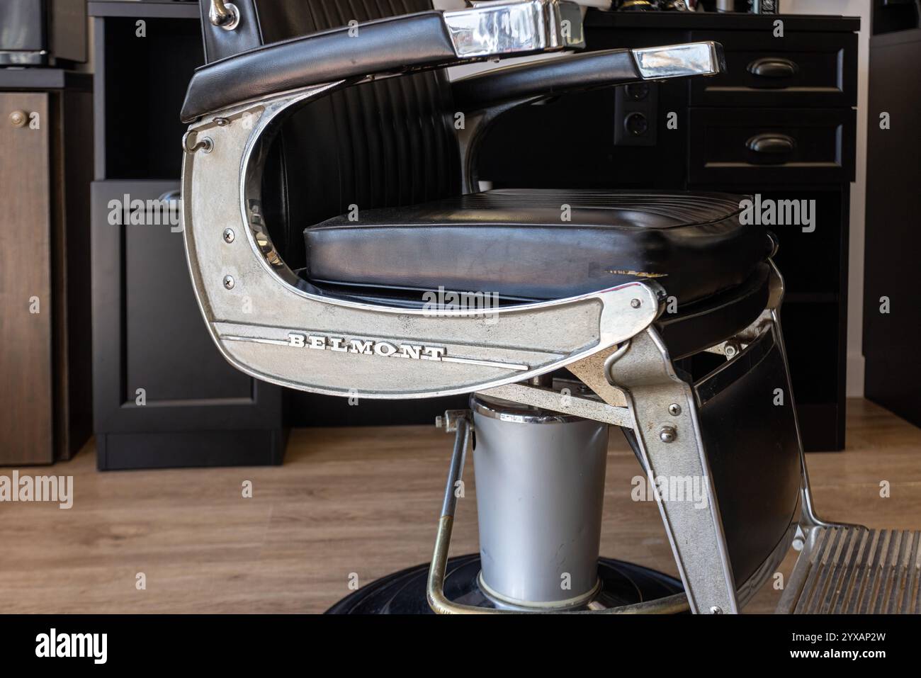 Detailed side view of a Belmont barber chair with a metallic frame ...