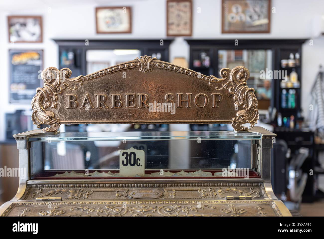 Close-up of a vintage cash register with a decorative "Barber Shop ...