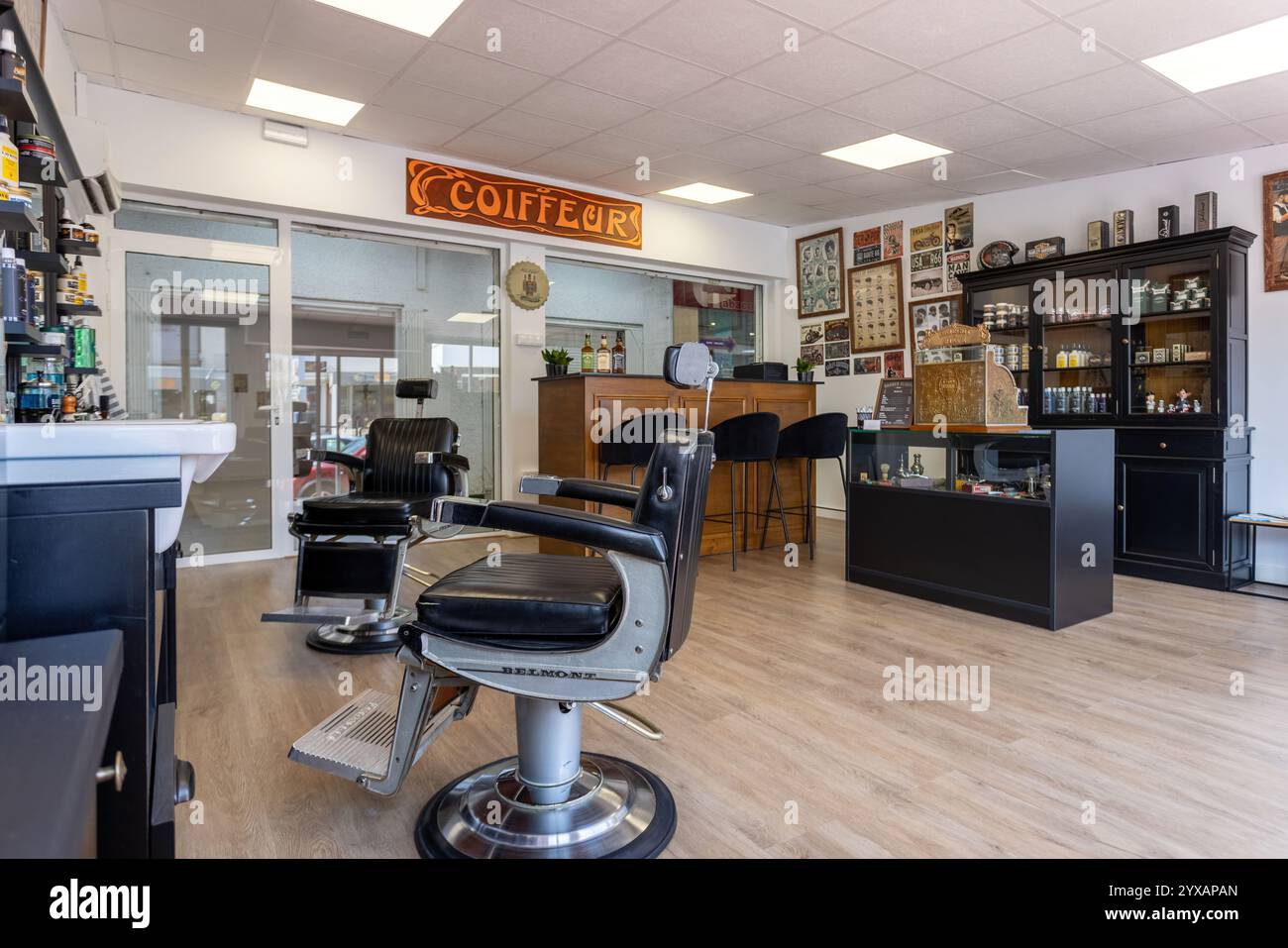Wide view of a barber shop interior featuring Belmont chairs, retro ...