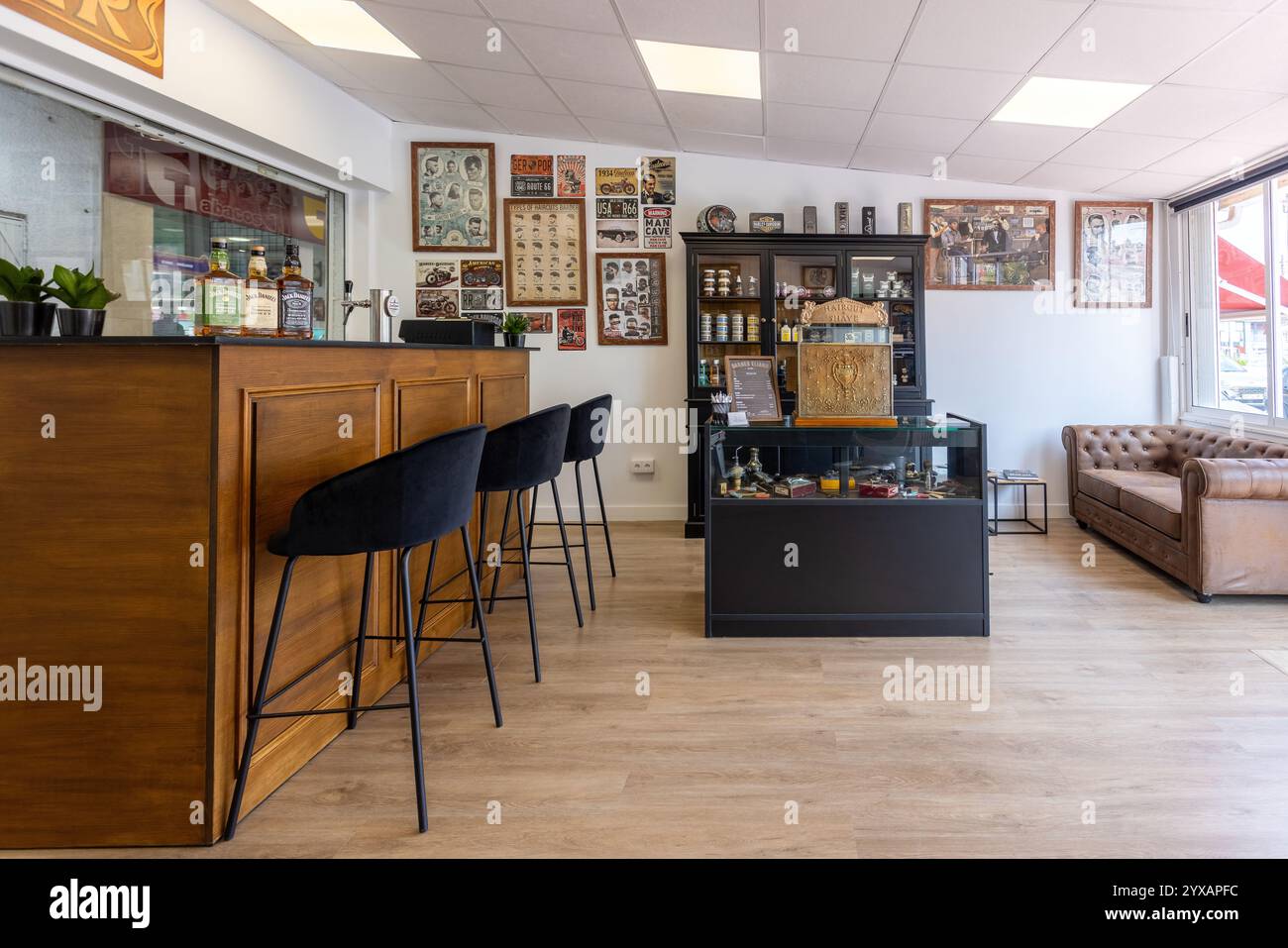 A stylish barber shop reception area featuring a wooden counter with ...