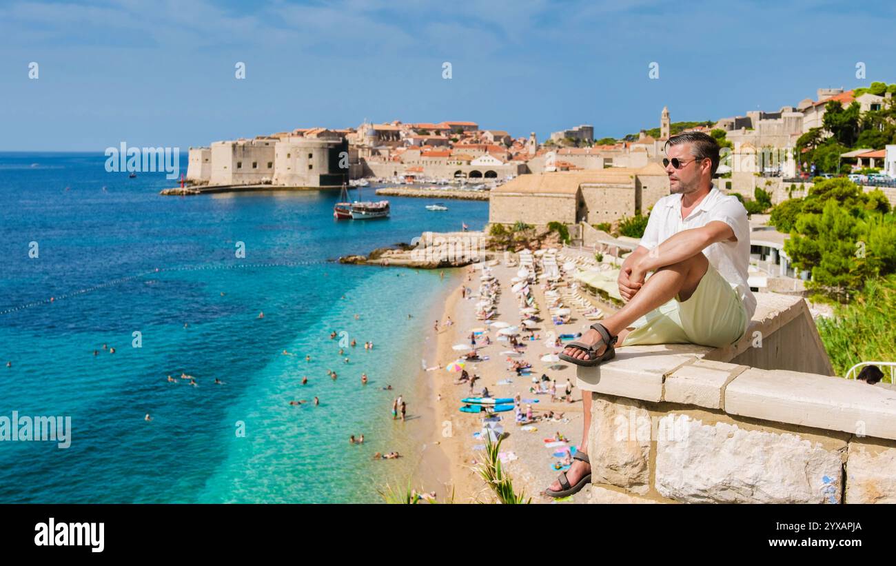 A male traveler enjoys a serene moment by the Adriatic Sea, overlooking ...