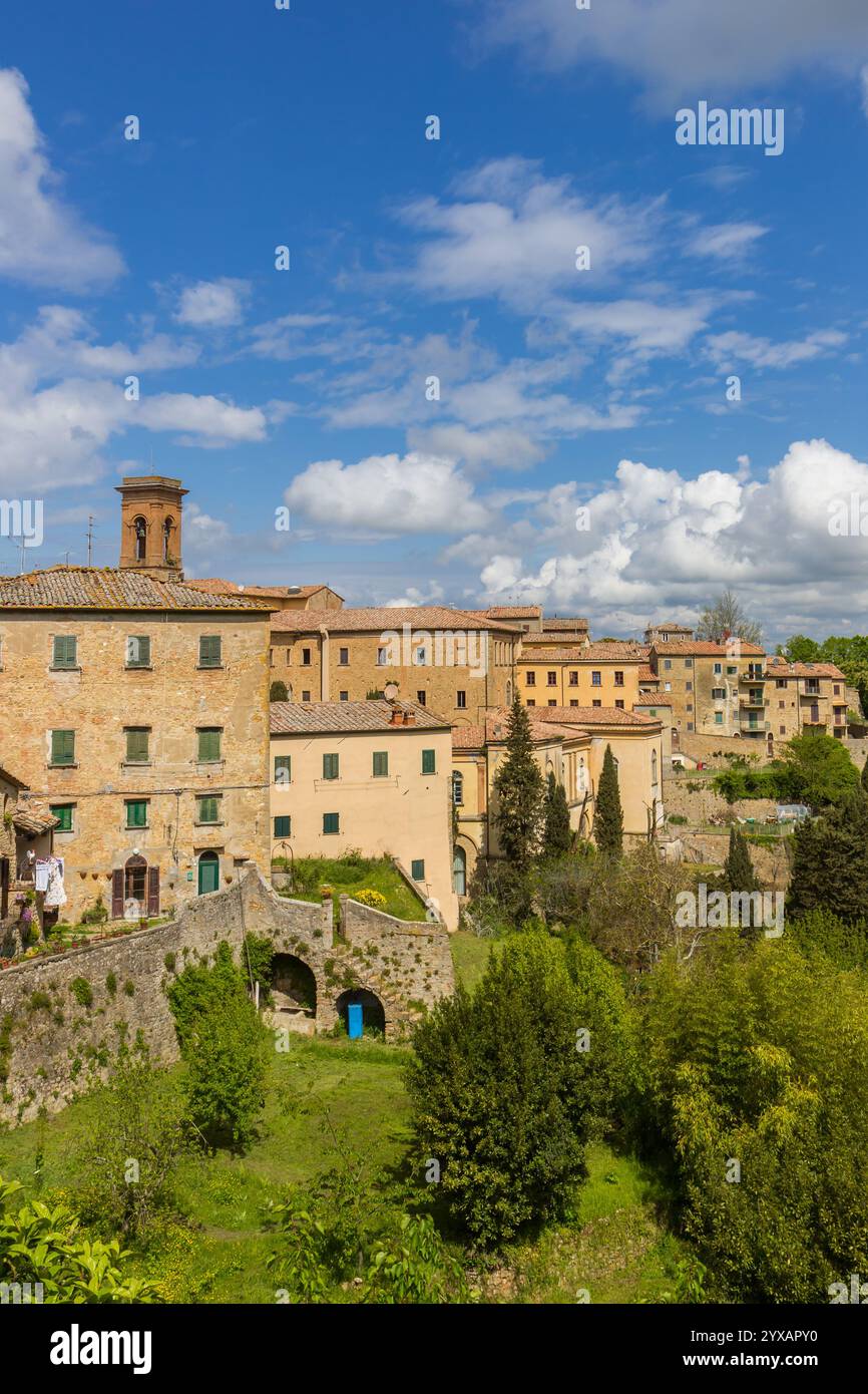 Historic city wall in front of houses in Volterra, Italy Stock Photo ...