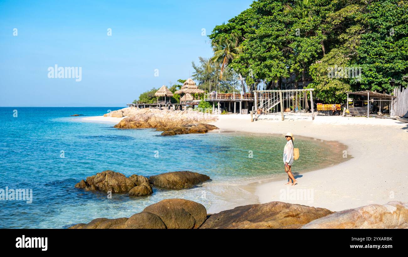 A serene stroll on the white sandy beach of Koh Munnork Island reveals ...