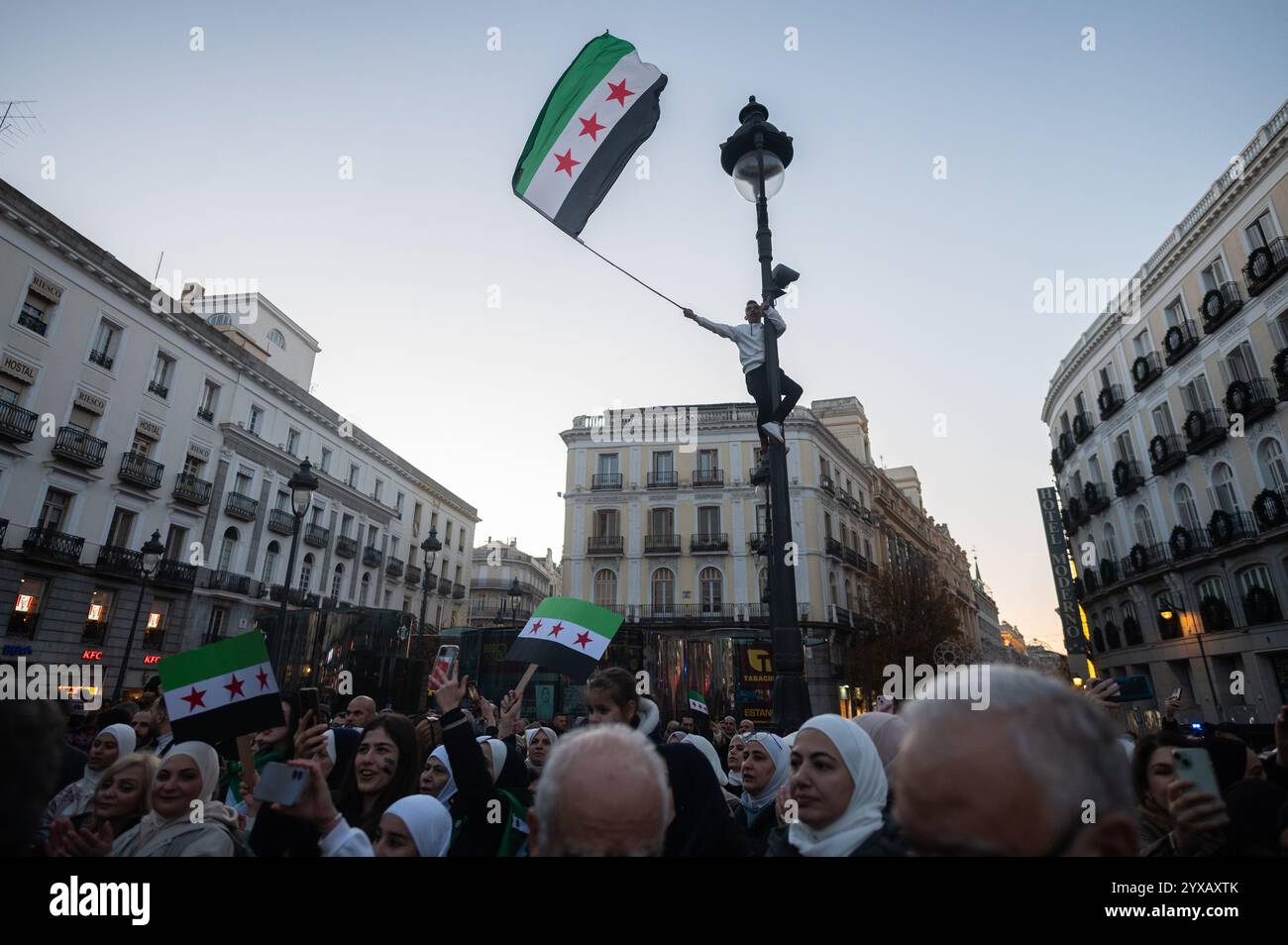 Madrid, Spain. 14th Dec, 2024. A man holds the Syrian Rebel flag during ...