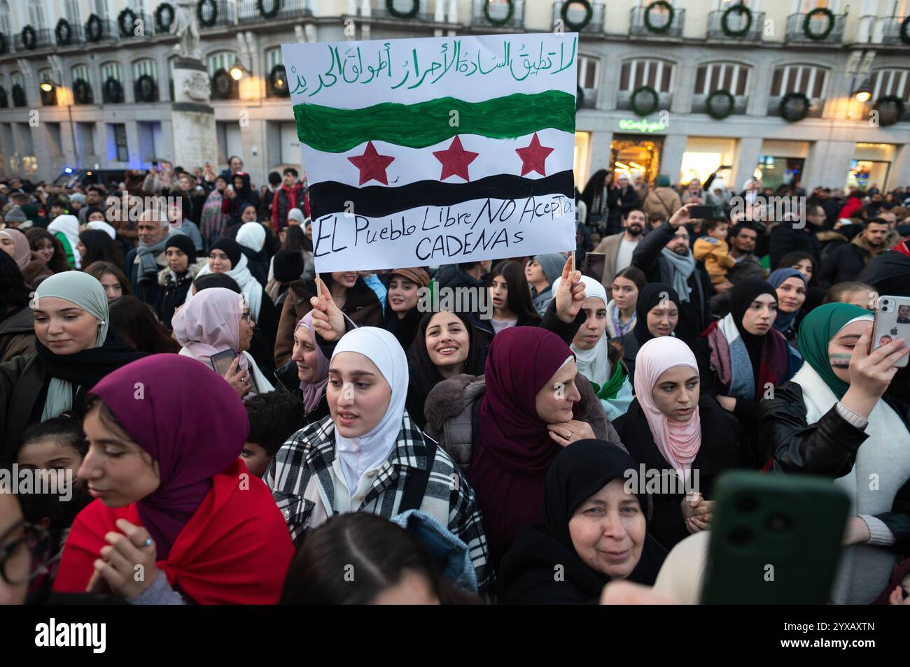 Madrid, Spain. 14th Dec, 2024. A woman holds a placard with the Syrian ...