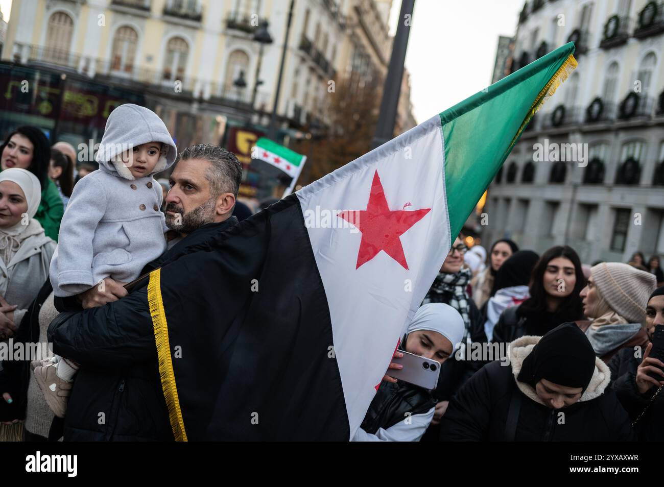 Madrid, Spain. 14th Dec, 2024. A man holds the Syrian Rebel flag during ...