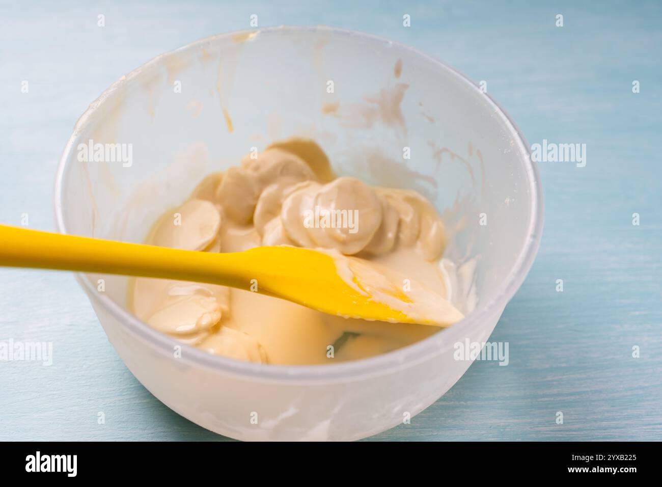Tempering of white professional chocolate. The process of making ...