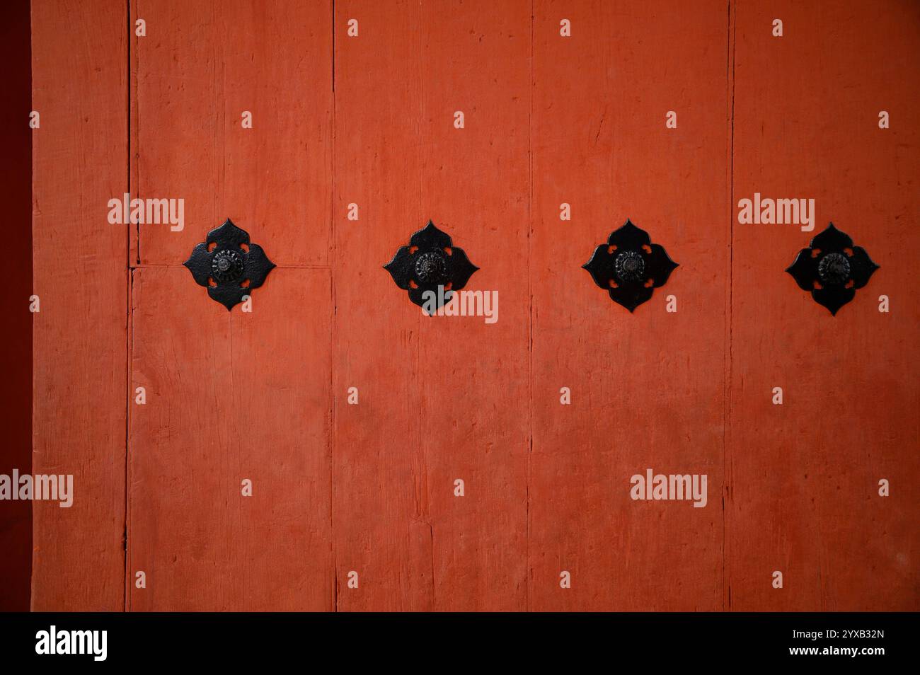 Closeup detail of a vermilion Torii gate with handcrafted iron studs at ...