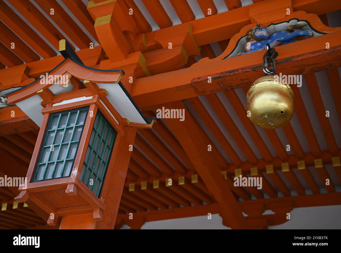 Golden Suzu a traditional Japanese bell next to a hanging lantern on ...