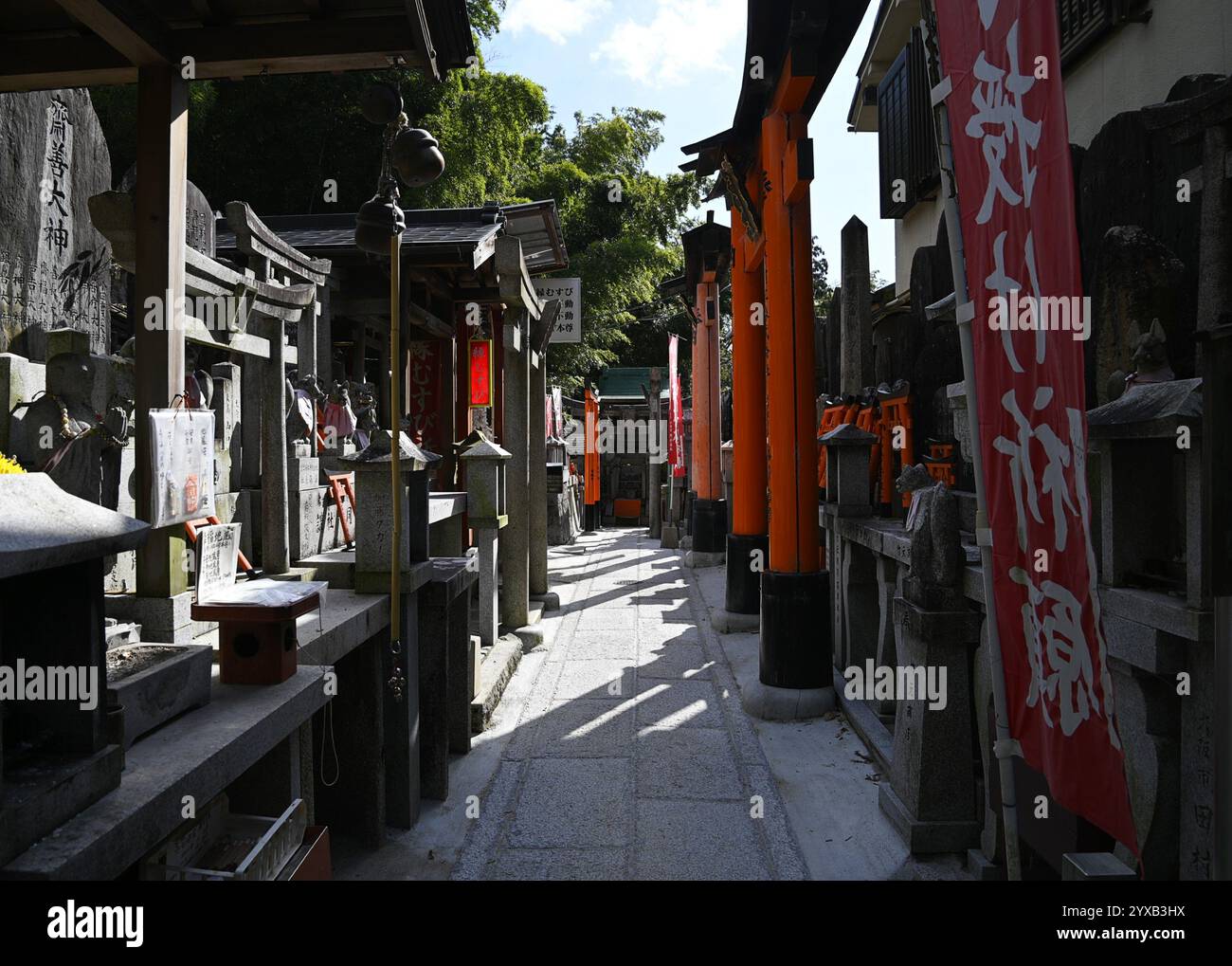 Shinto graveyard at the Shrine Fushimi Inari-taisha with Otsuka stones, kitsune foxes and ...