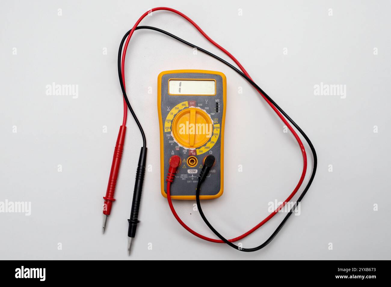 Yellow and gray digital multimeter with probes showing one on display ...
