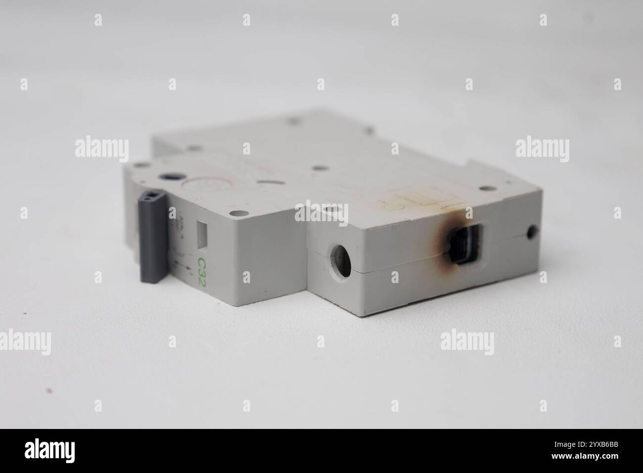 Damaged circuit breaker displaying burn marks from electrical overload ...